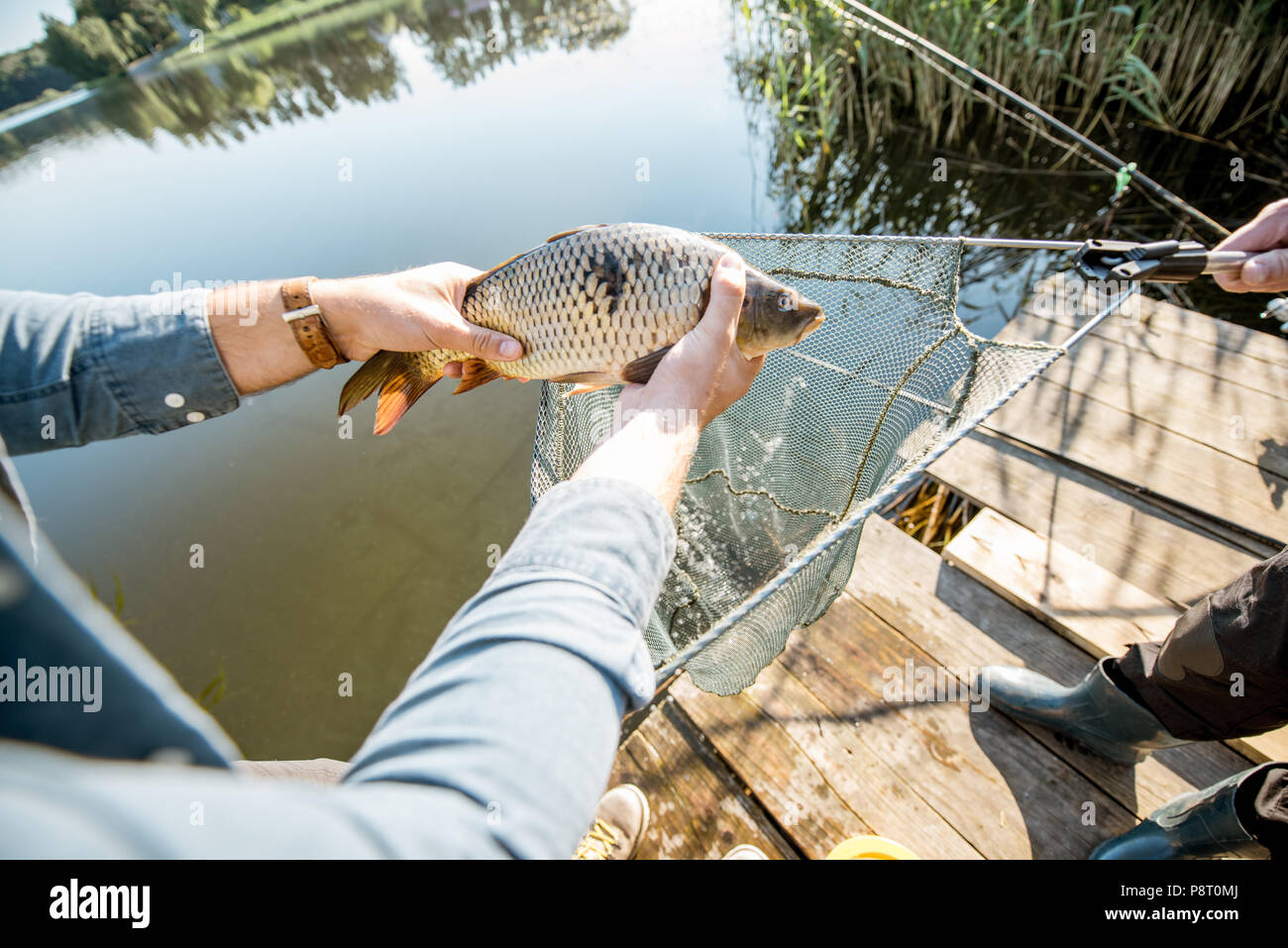 Fisherman with caught fish hi-res stock photography and images - Alamy