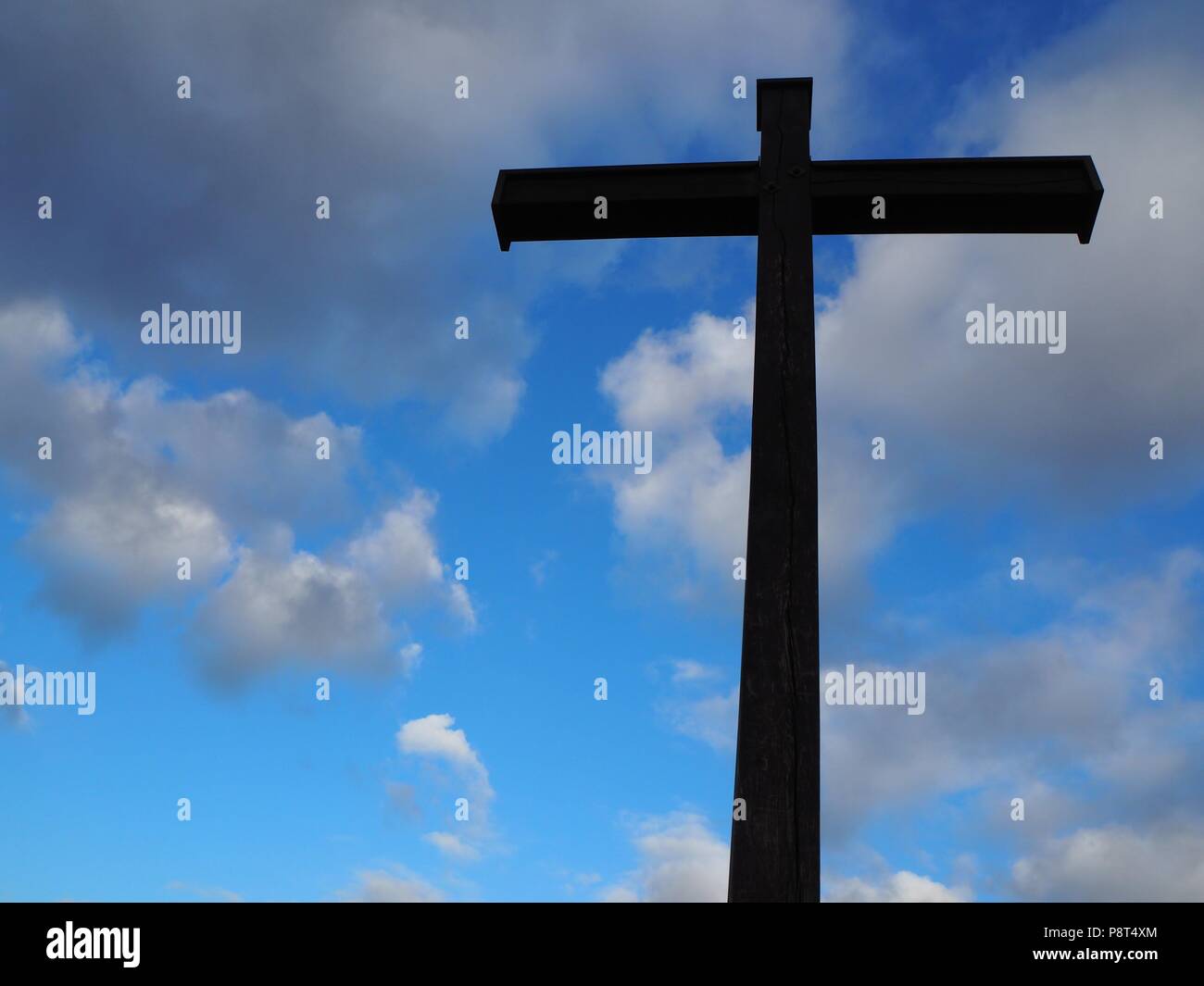Cross along a pathway with blue sky in the background Stock Photo - Alamy