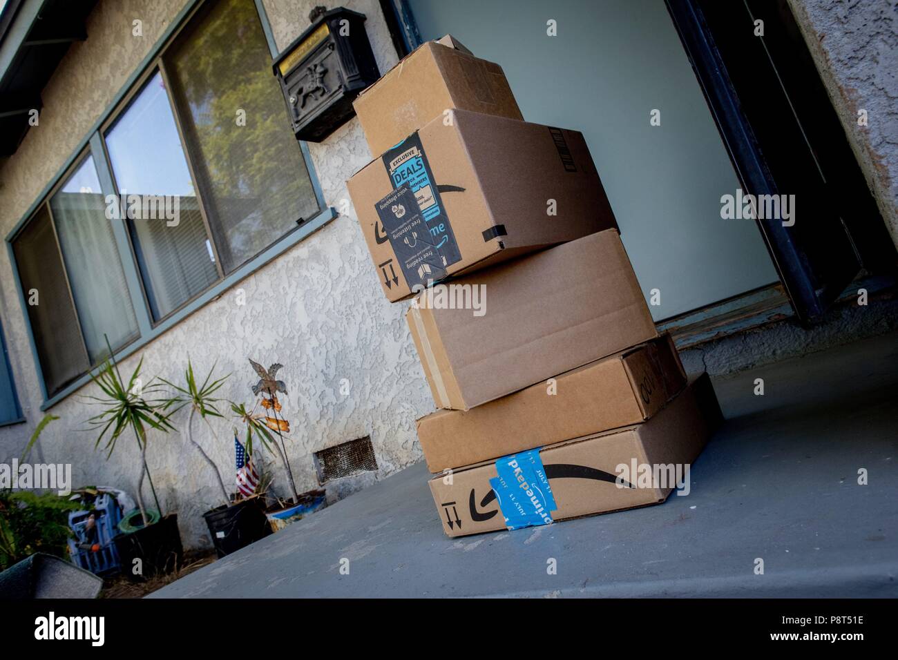 Packages piling up at a door in a residential neighborhood in San Diego ...