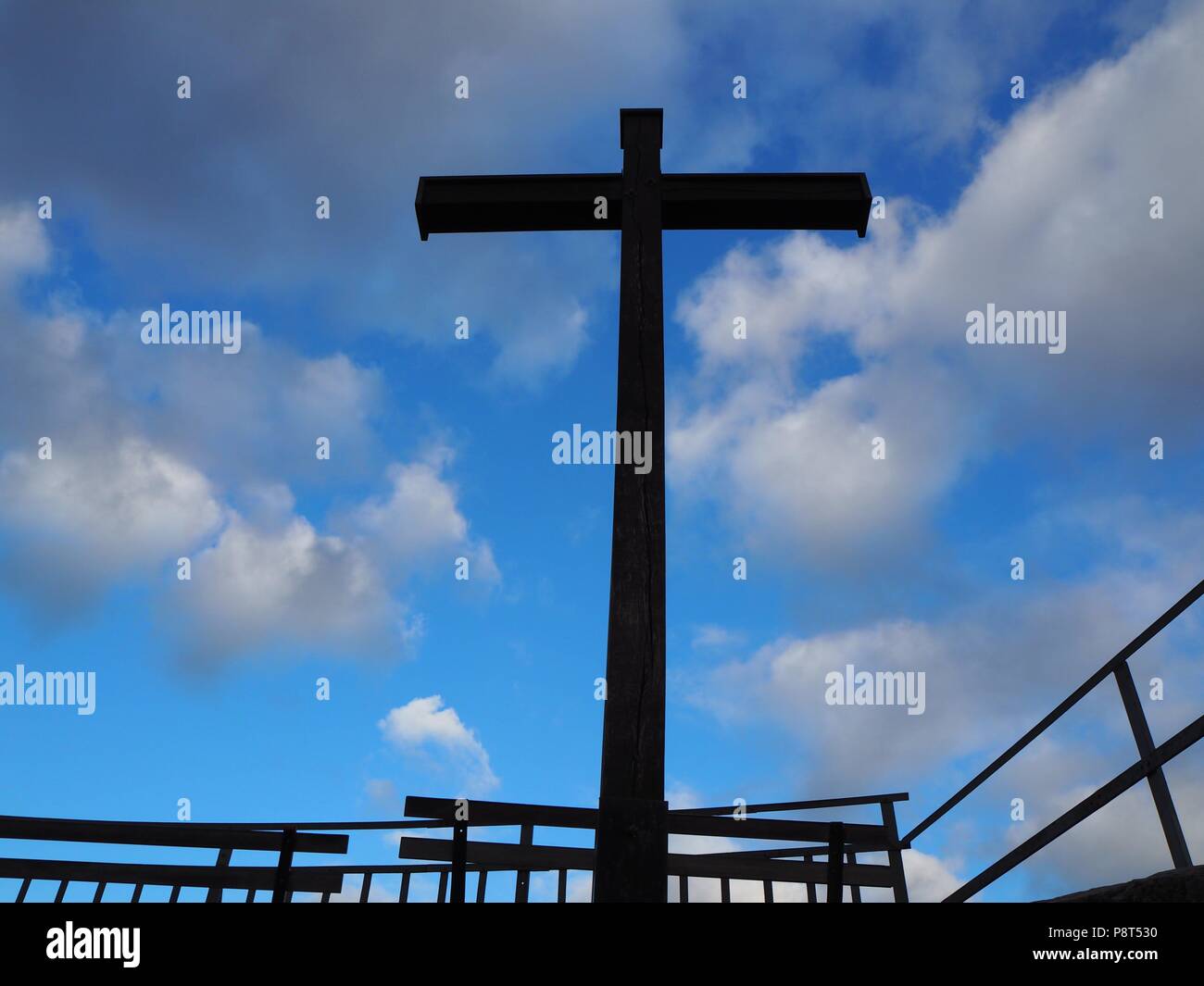 Cross along a pathway with blue sky in the background Stock Photo - Alamy