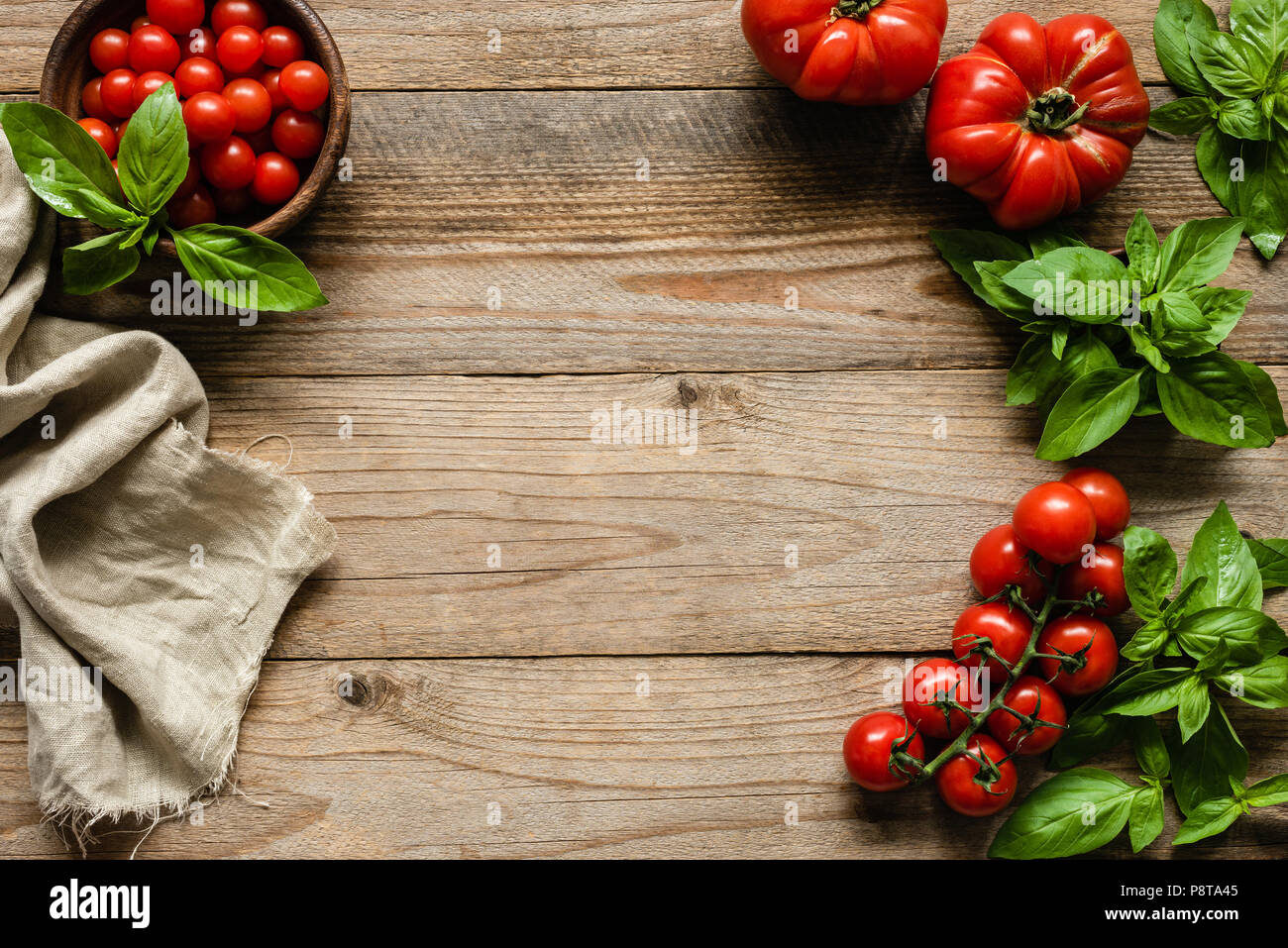 Tomatoes, basil and textile on wooden background, cooking food. Rustic ...