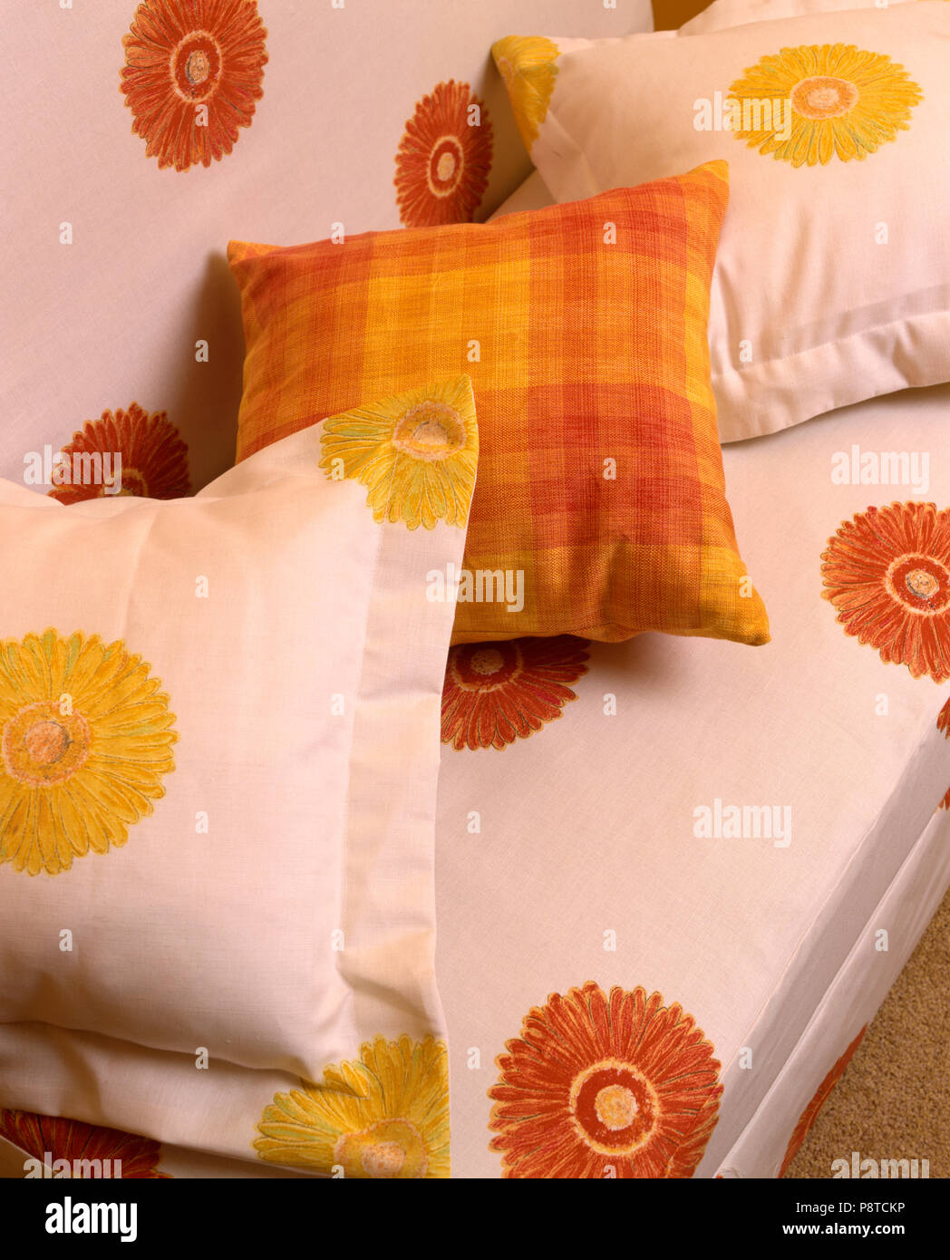 Three cushions on a flower pattern sofa Stock Photo - Alamy