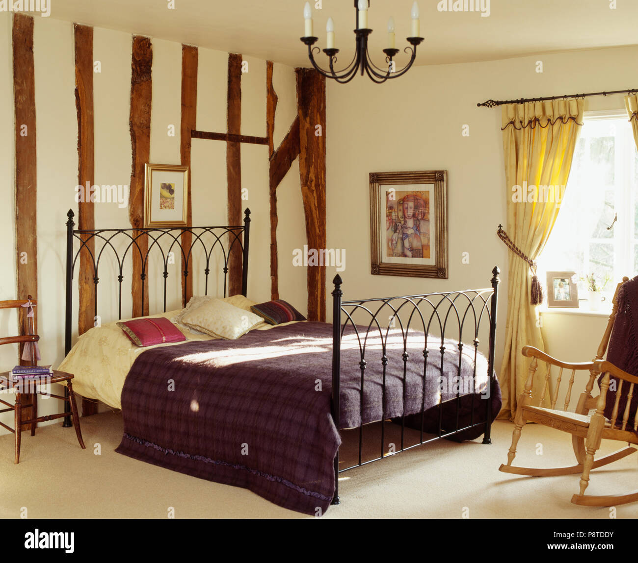 Large traditional bedrooms with rocking chair and iron framed bed ...