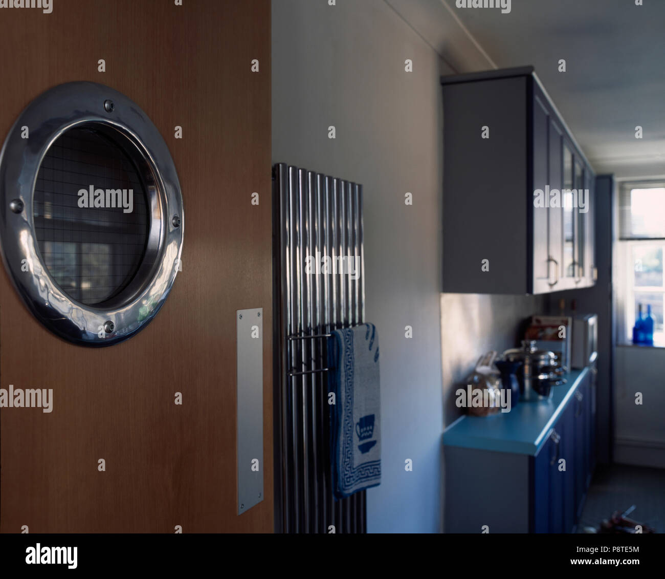 Door with porthole in modern townhouse kitchen Stock Photo - Alamy