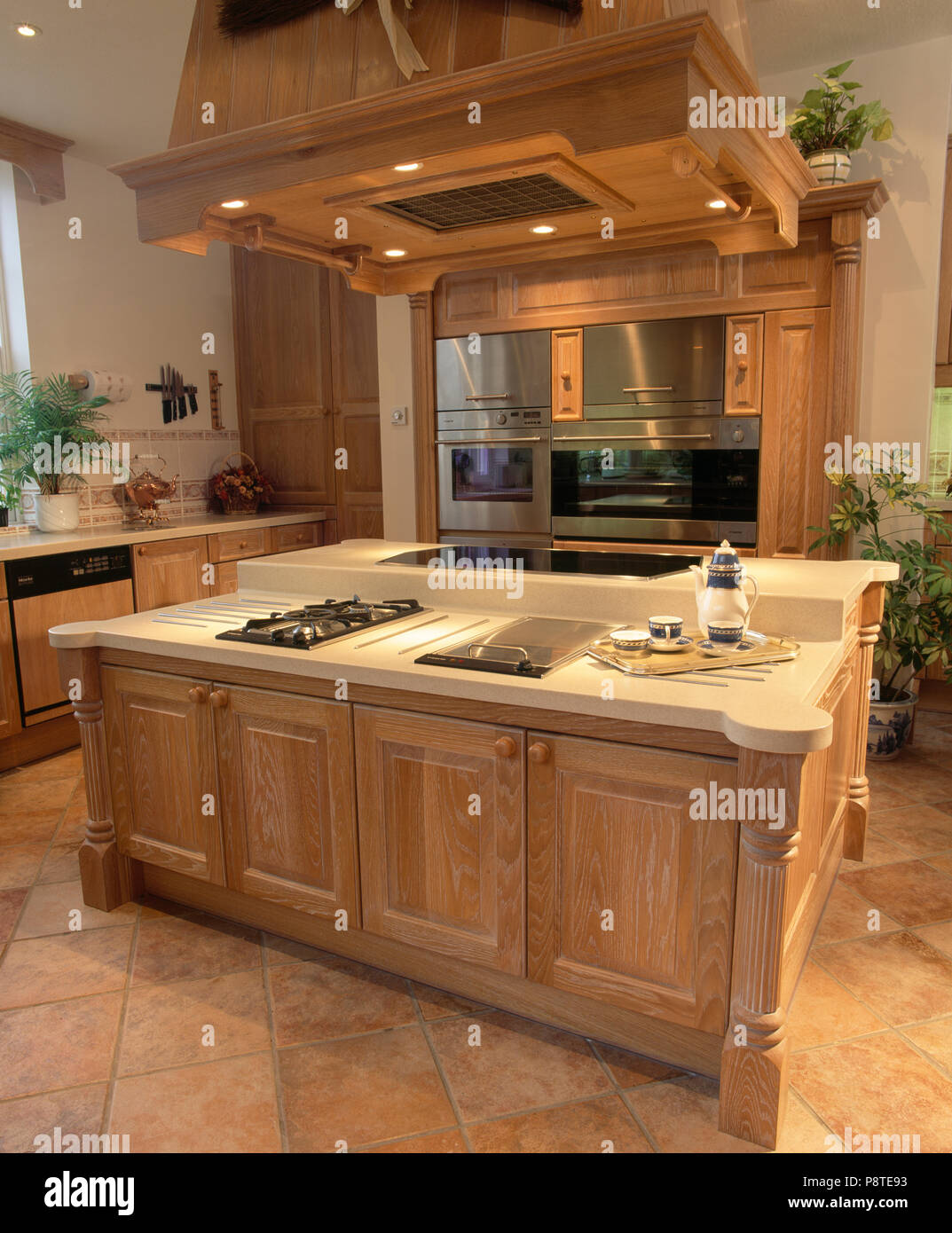 Extractor in fitted wooden unit above hob in island unit in large ...