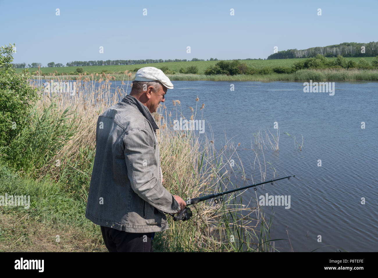 Fisherman standing on river bank hi-res stock photography and images ...