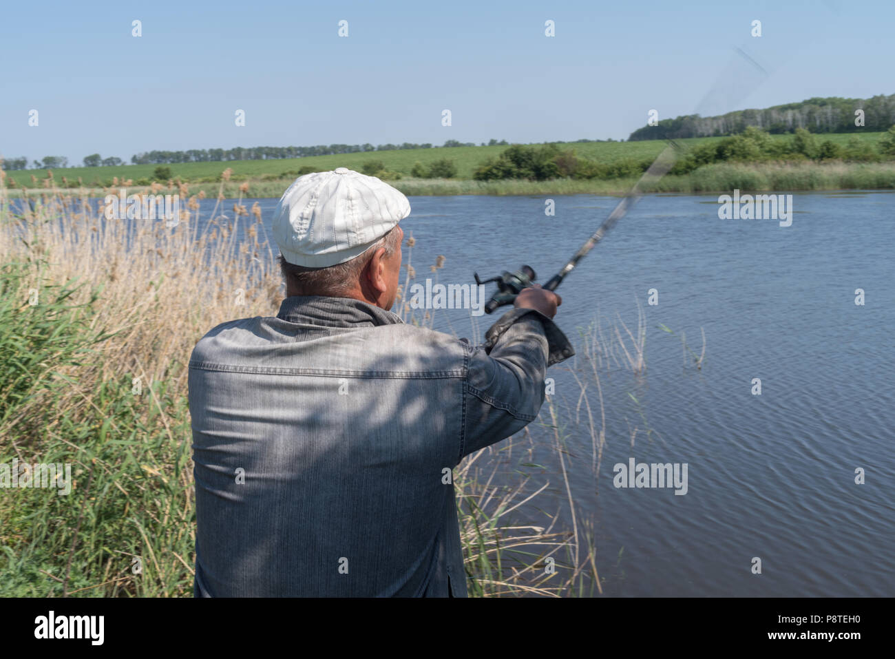 Man fishing back view hi-res stock photography and images - Alamy