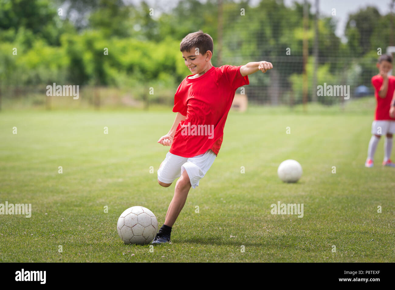 Little Boy Shooting at Goal Stock Photo - Alamy