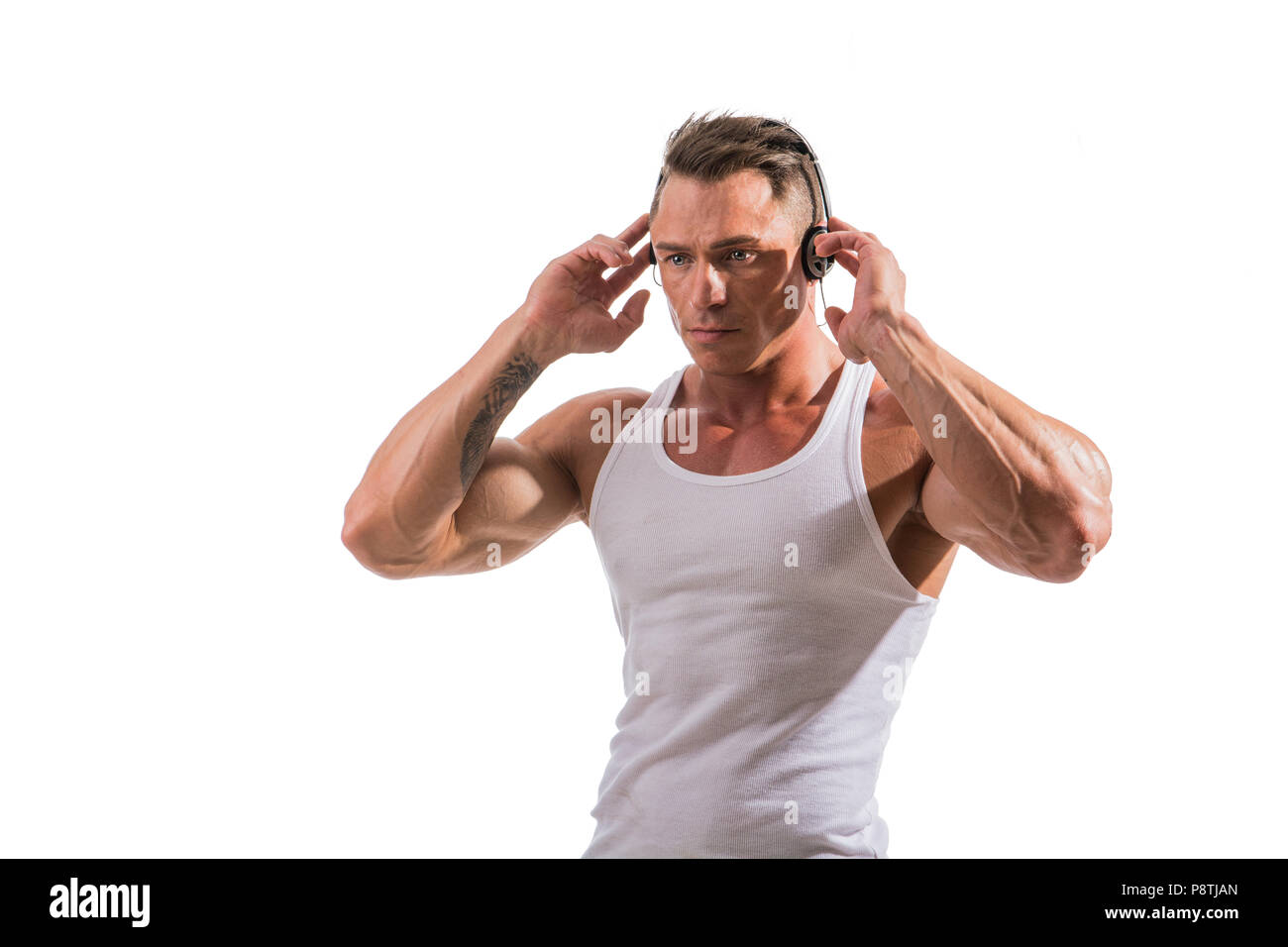 Muscular bodybuilder listening to music with headphones Stock Photo - Alamy