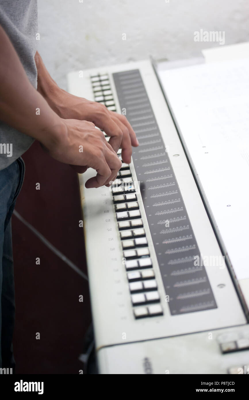 Printer checking a print run at table Stock Photo - Alamy