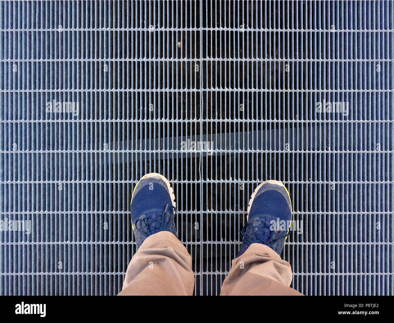 Walking on an iron grate Stock Photo - Alamy