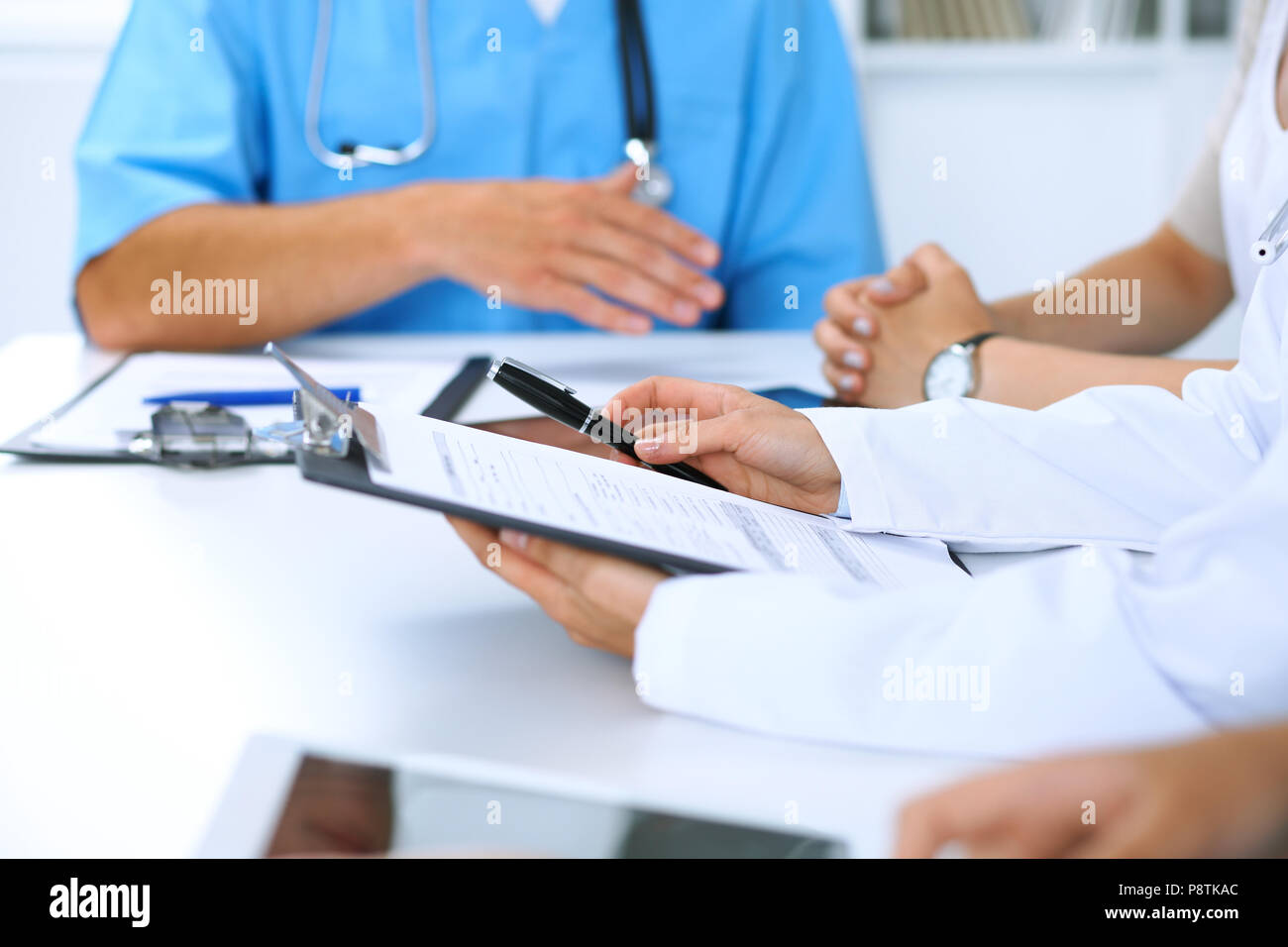Group of doctors discussing diseases and treatment at medical meeting ...