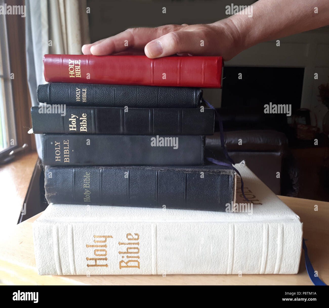 A hand on top of a stack of bibles is ready to swear the truth Stock ...