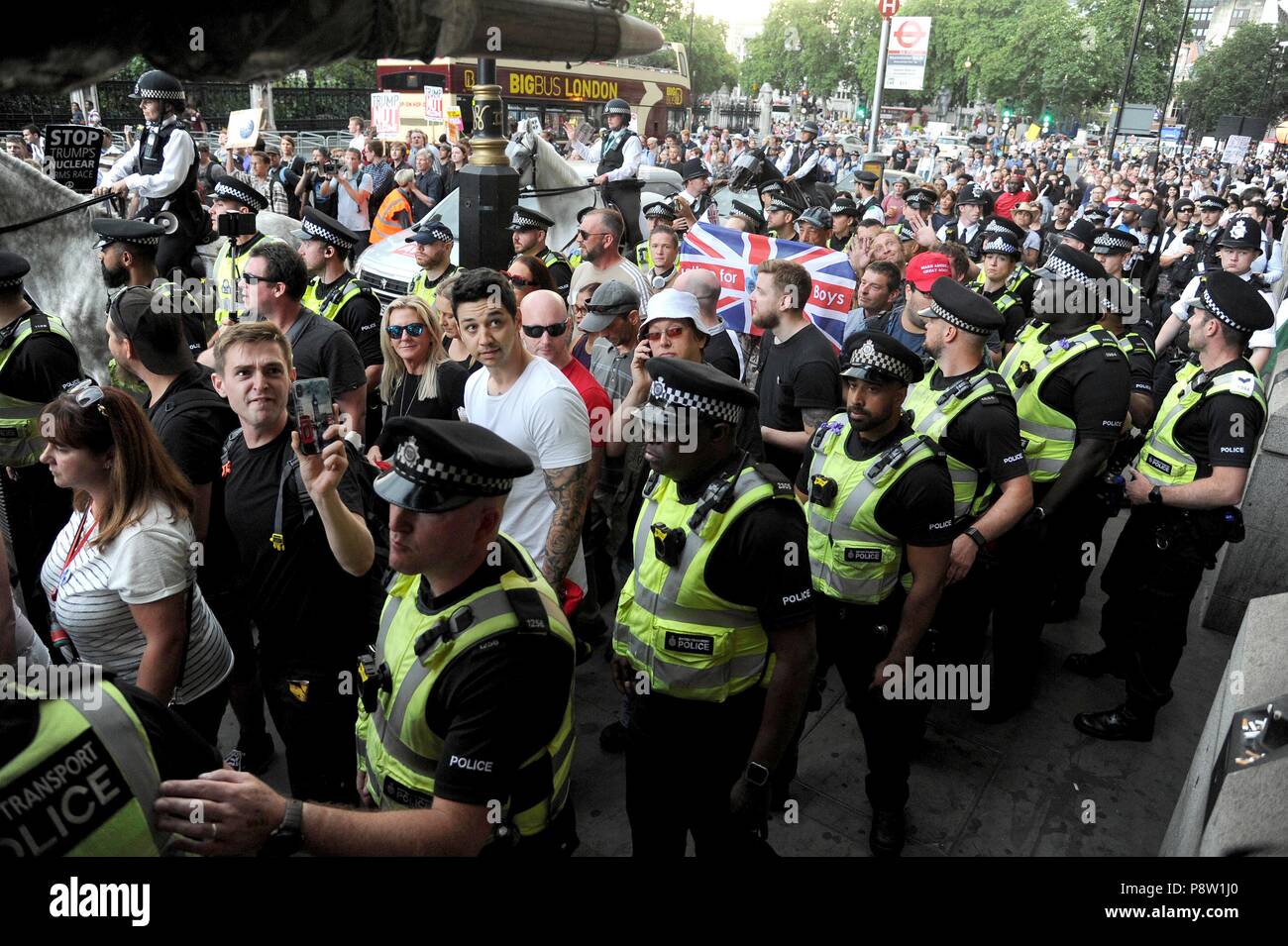 EDL supporters are escorted by police from The Red Lion pub during anti ...