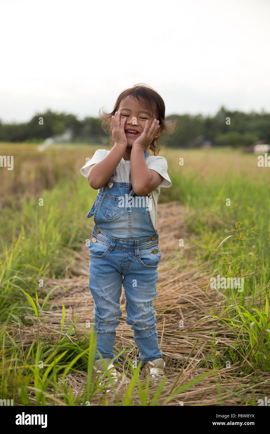 happy young asian child smiling to camera in paddy rice field Stock ...