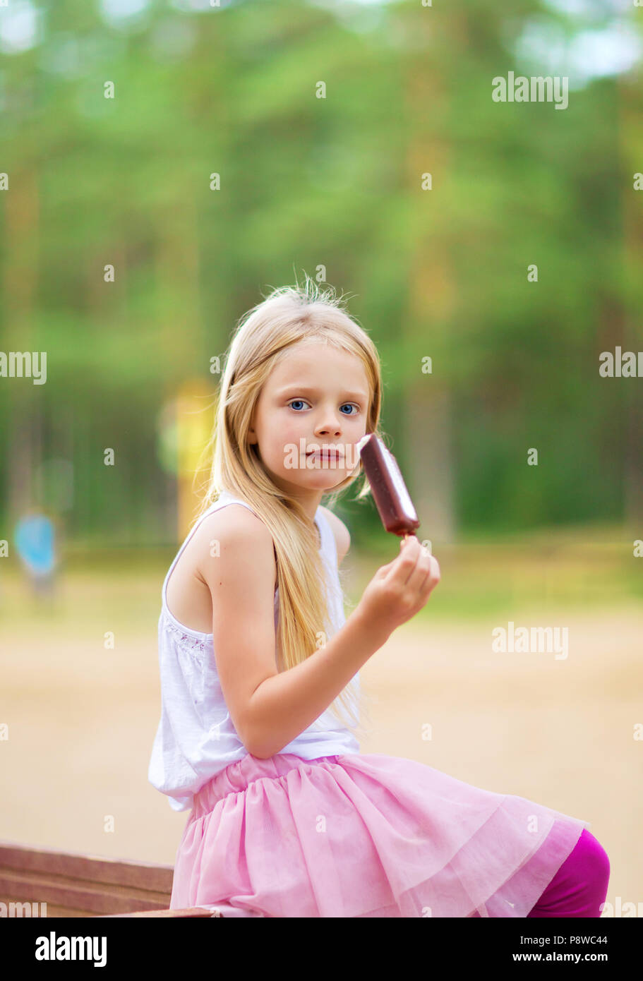 Little girl eats stick ice cream bar eskimo pie outdoors Stock Photo ...