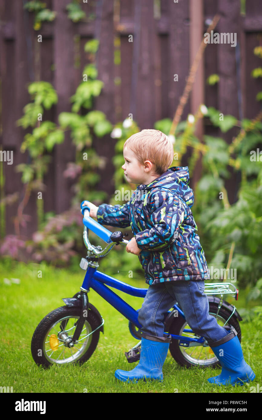 Little boy riding bicycle outdoors in park Stock Photo - Alamy
