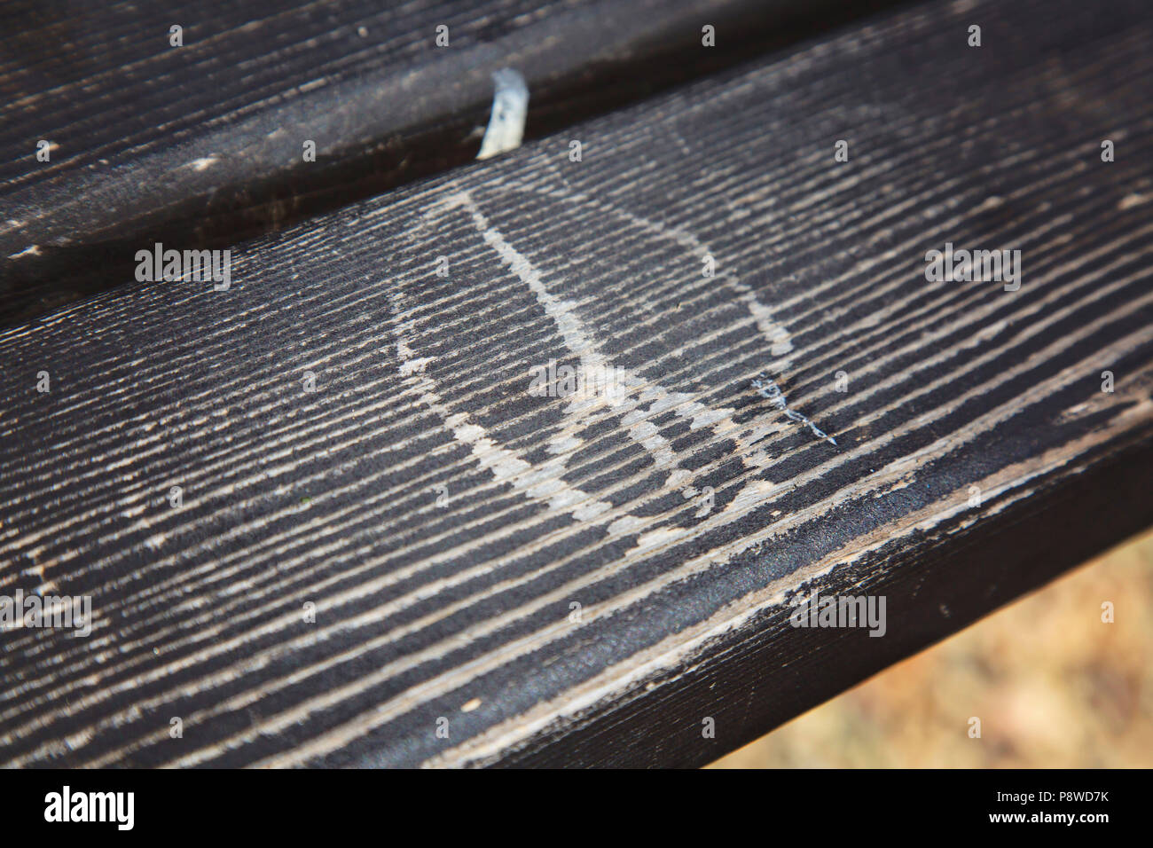 Peace symbol engraved into public wooden seat Stock Photo - Alamy
