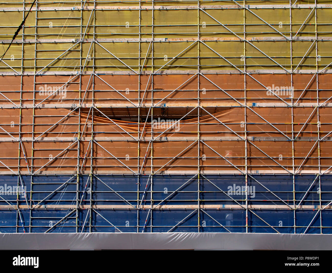 Scaffolding and a plastic wrapped building, france Stock Photo - Alamy