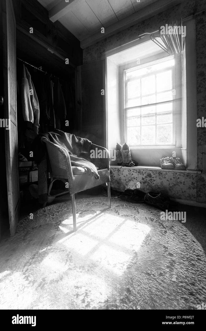 Farm house interior, room with chair and sunlit window (mono Stock ...