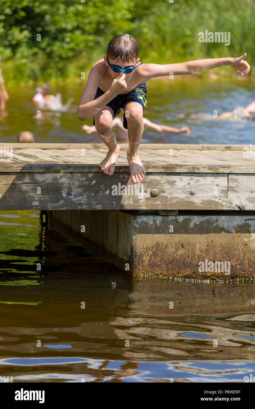 Boy jumping into water hi-res stock photography and images - Alamy