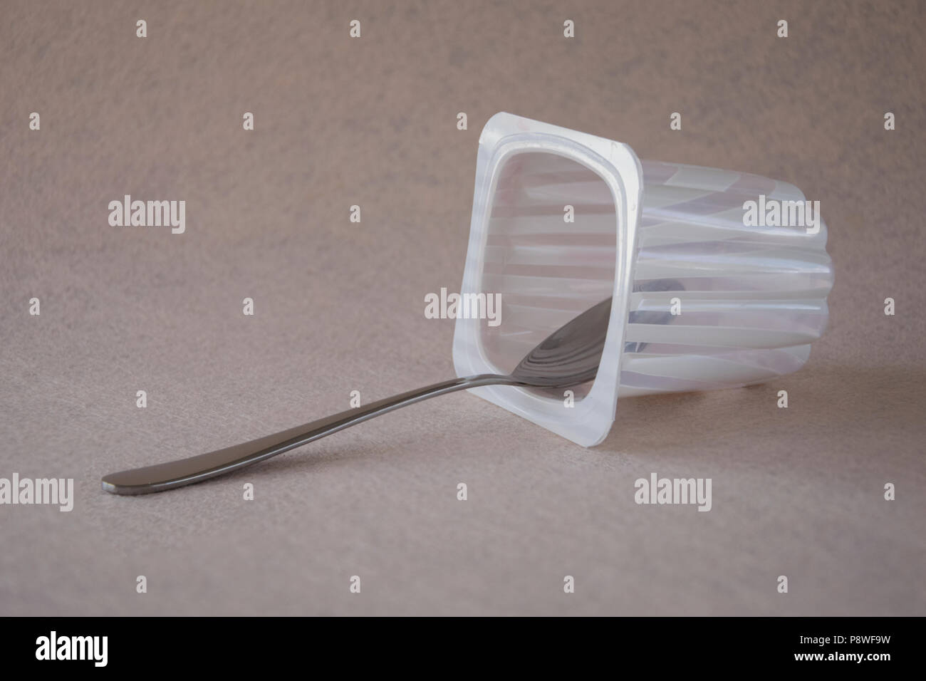 Empty container and spoon Stock Photo - Alamy