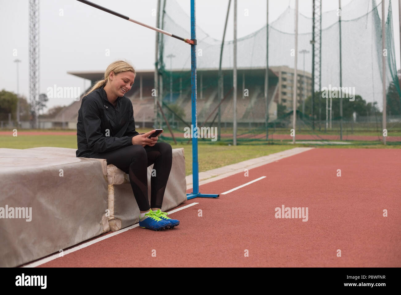 Female athlete using mobile phone Stock Photo - Alamy