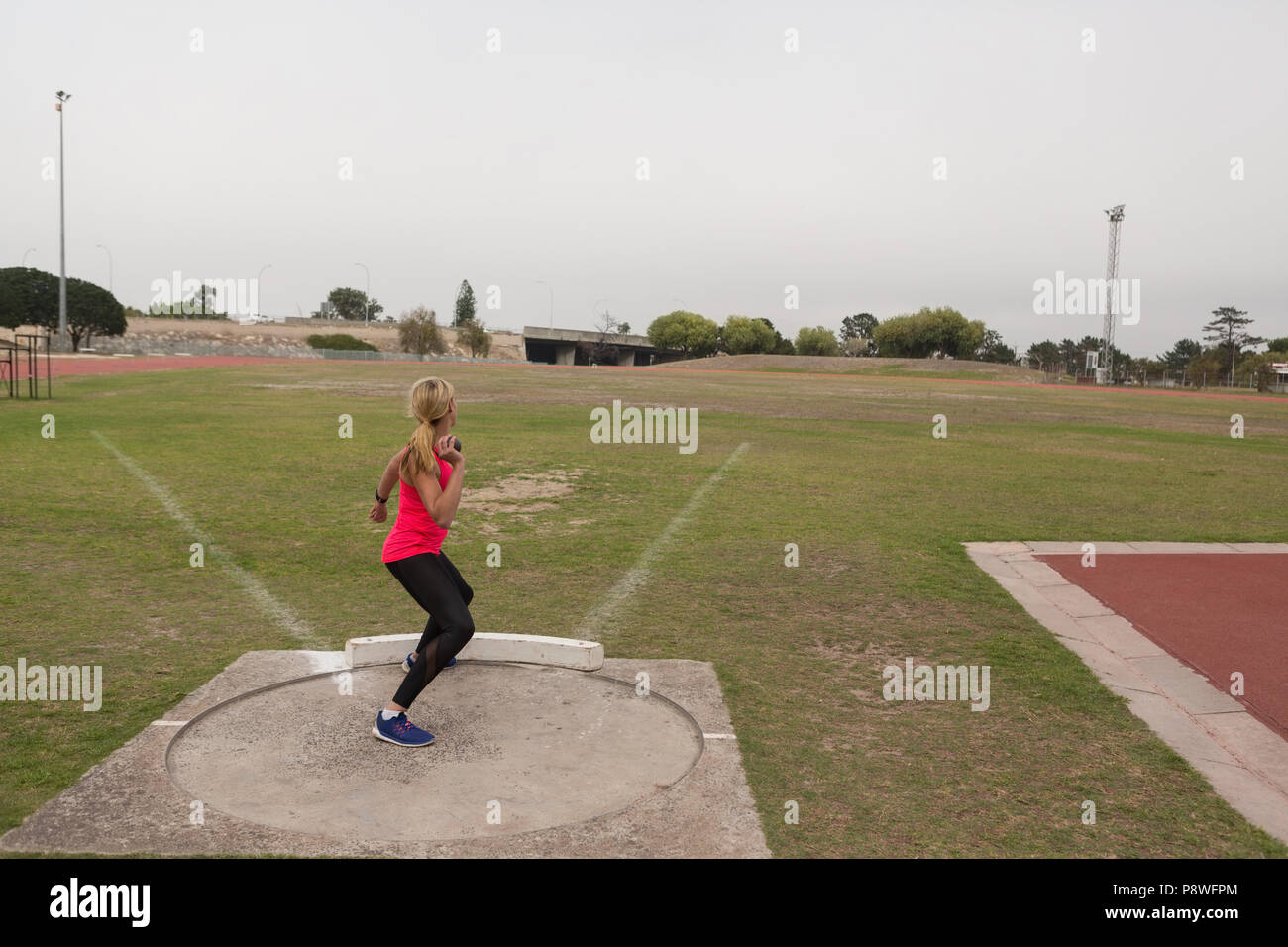 Female athlete practicing shot put Stock Photo - Alamy