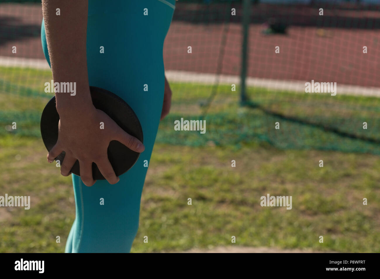 Female athlete practicing discus throw Stock Photo - Alamy