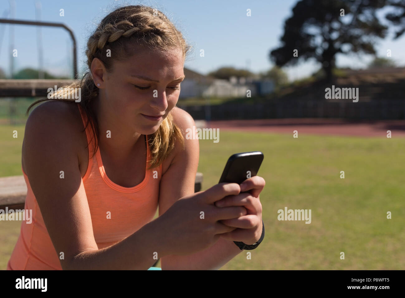 Female athlete using mobile phone Stock Photo - Alamy