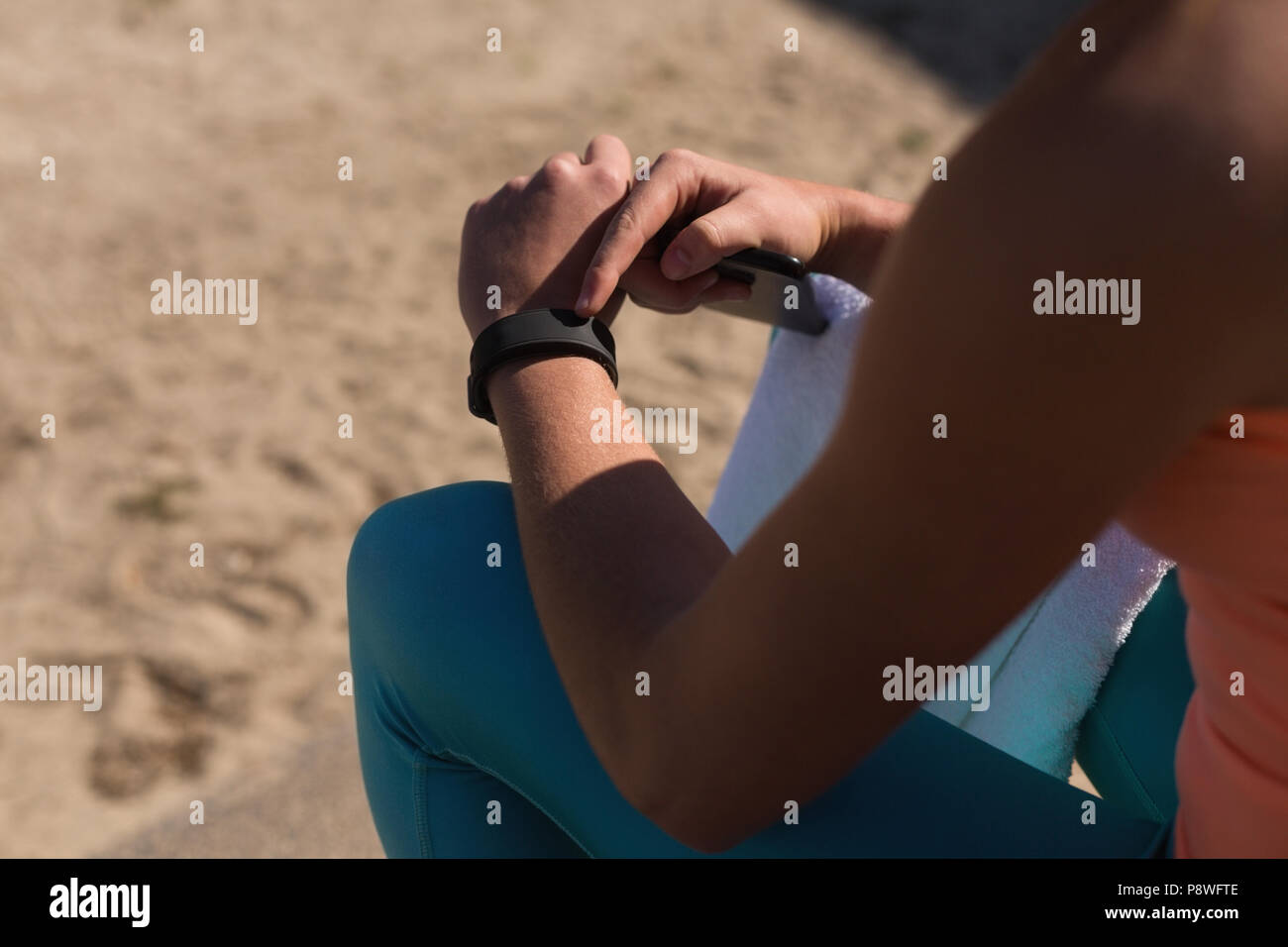 Female athlete using smartwatch Stock Photo - Alamy