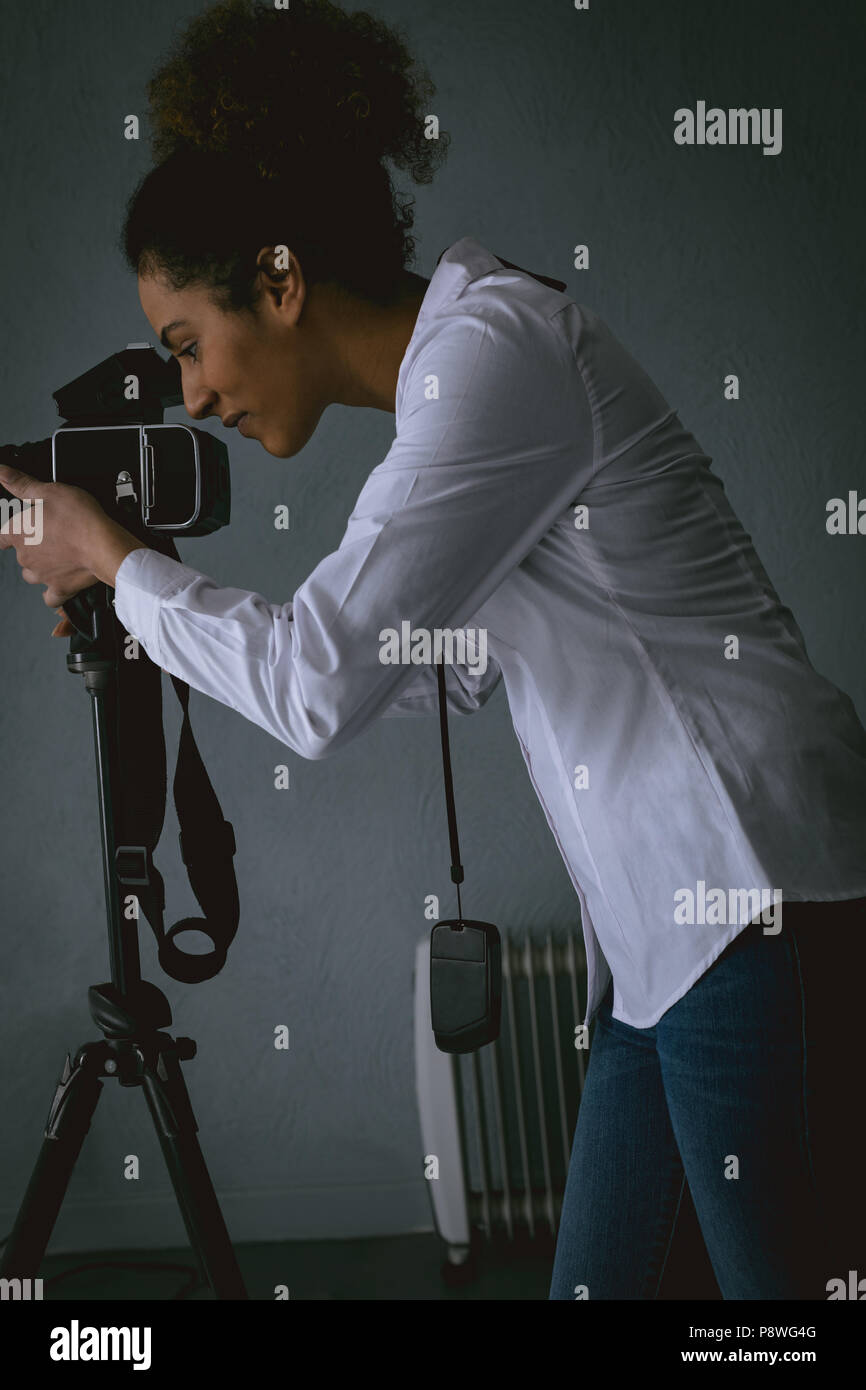 Female photographer clicking photos with digital camera Stock Photo - Alamy