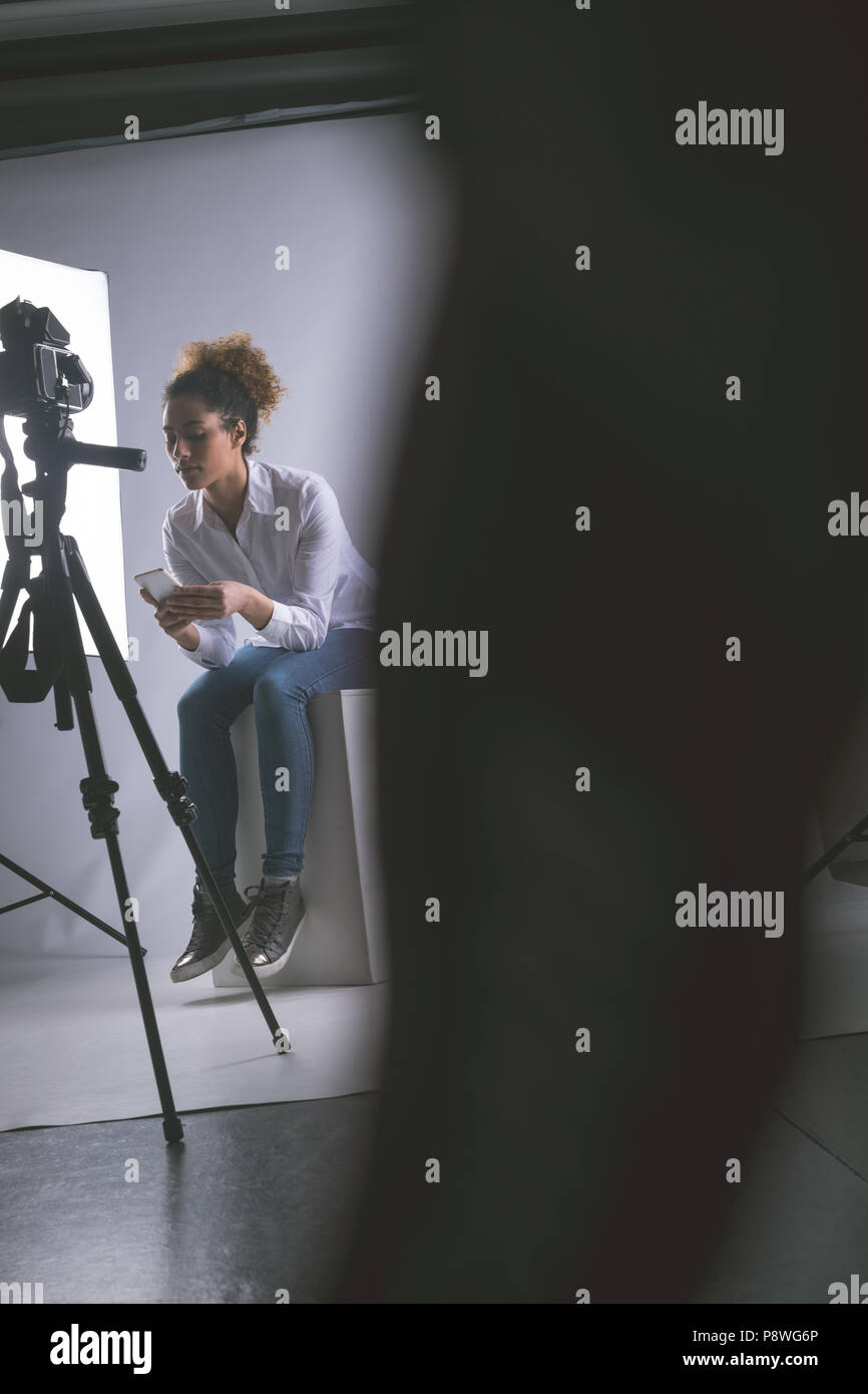 Female photographer using mobile phone Stock Photo - Alamy