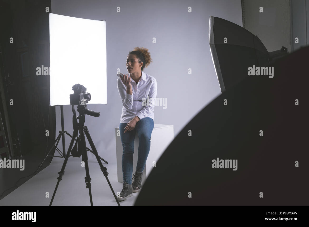 Female photographer talking on mobile phone Stock Photo - Alamy