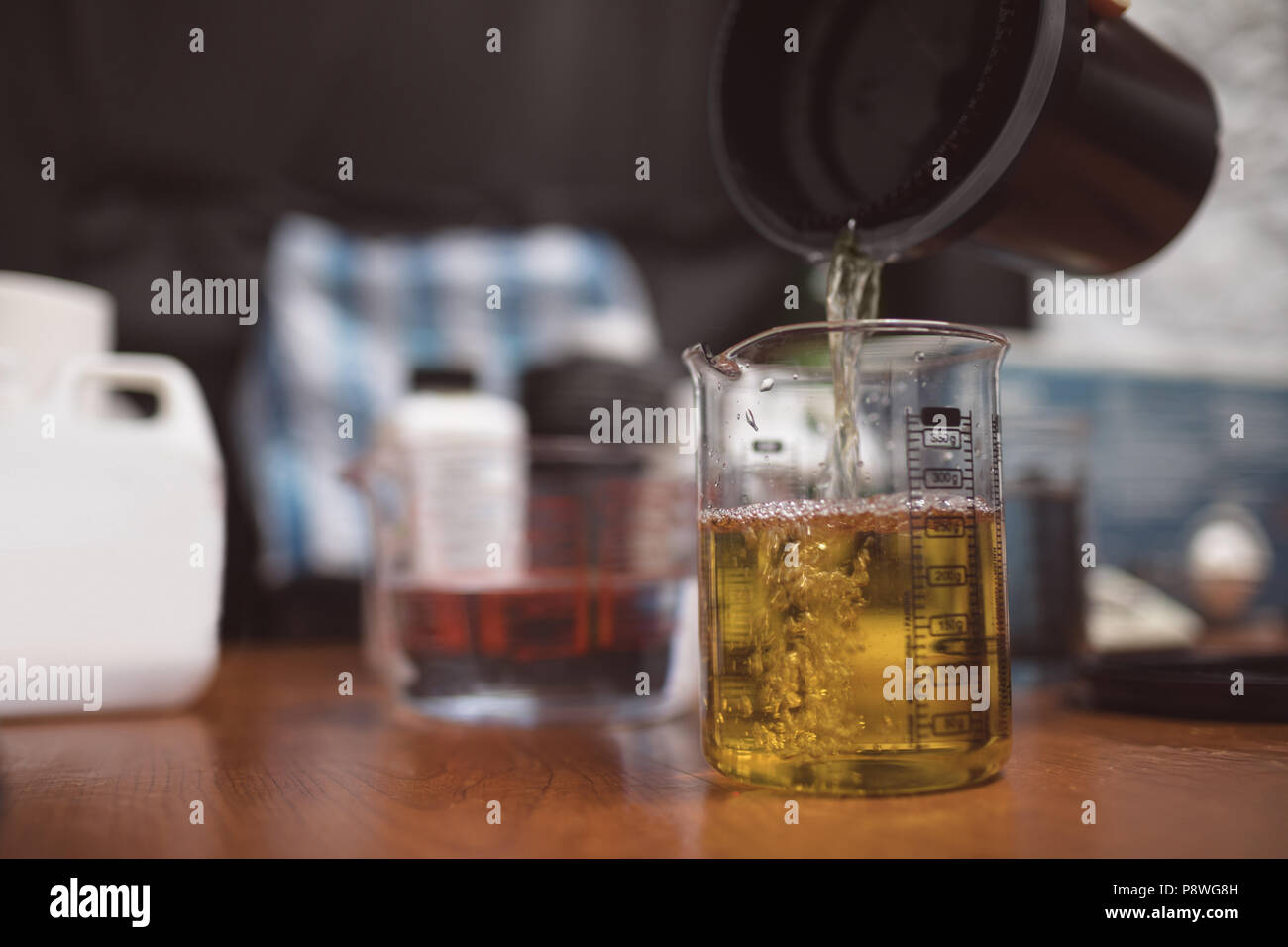 Female photographer pouring a chemical in flask Stock Photo - Alamy