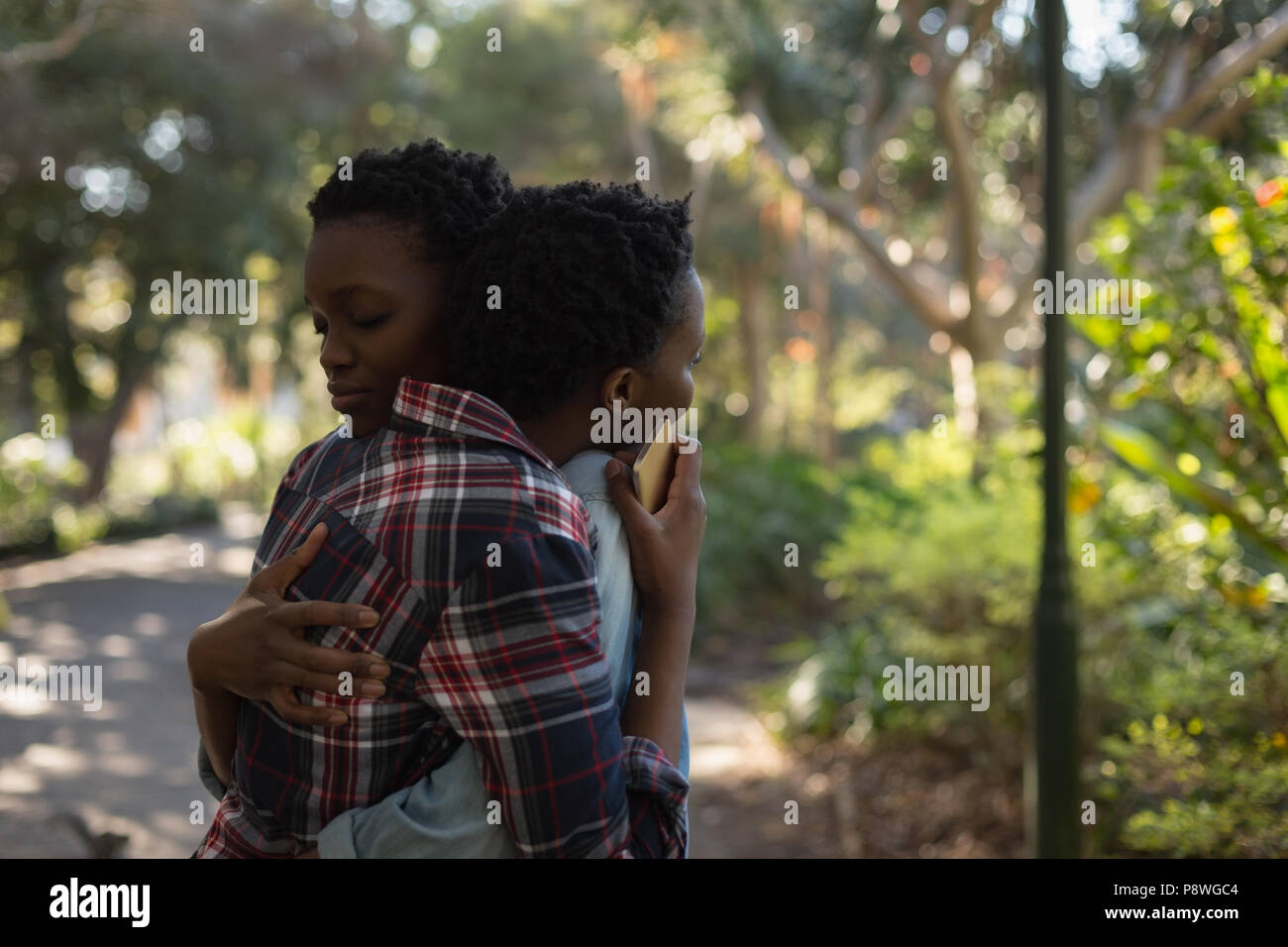 Twins siblings embracing each other Stock Photo - Alamy