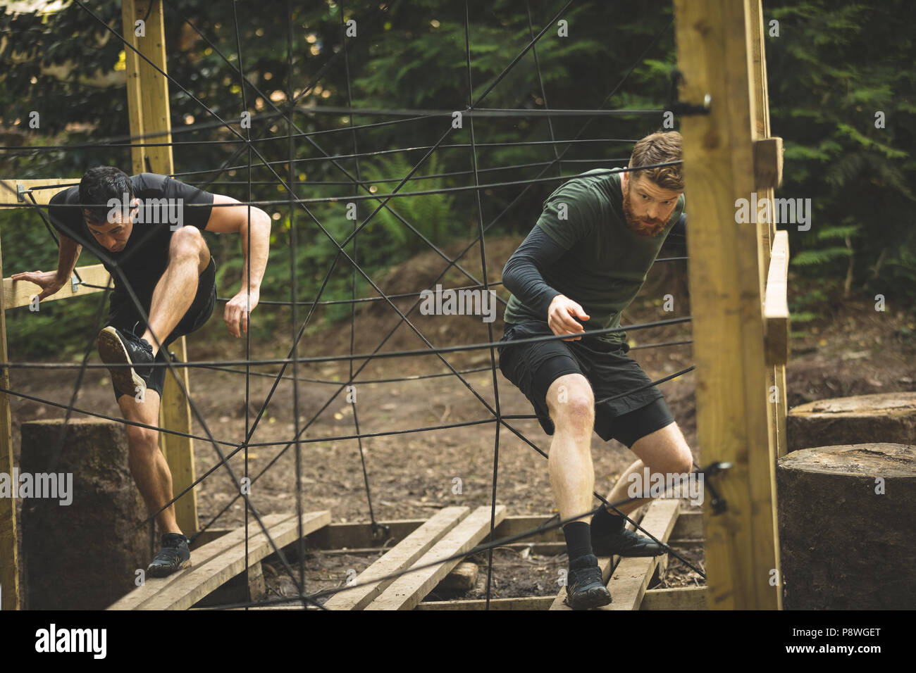 Two mens exercising on obstacle course Stock Photo - Alamy