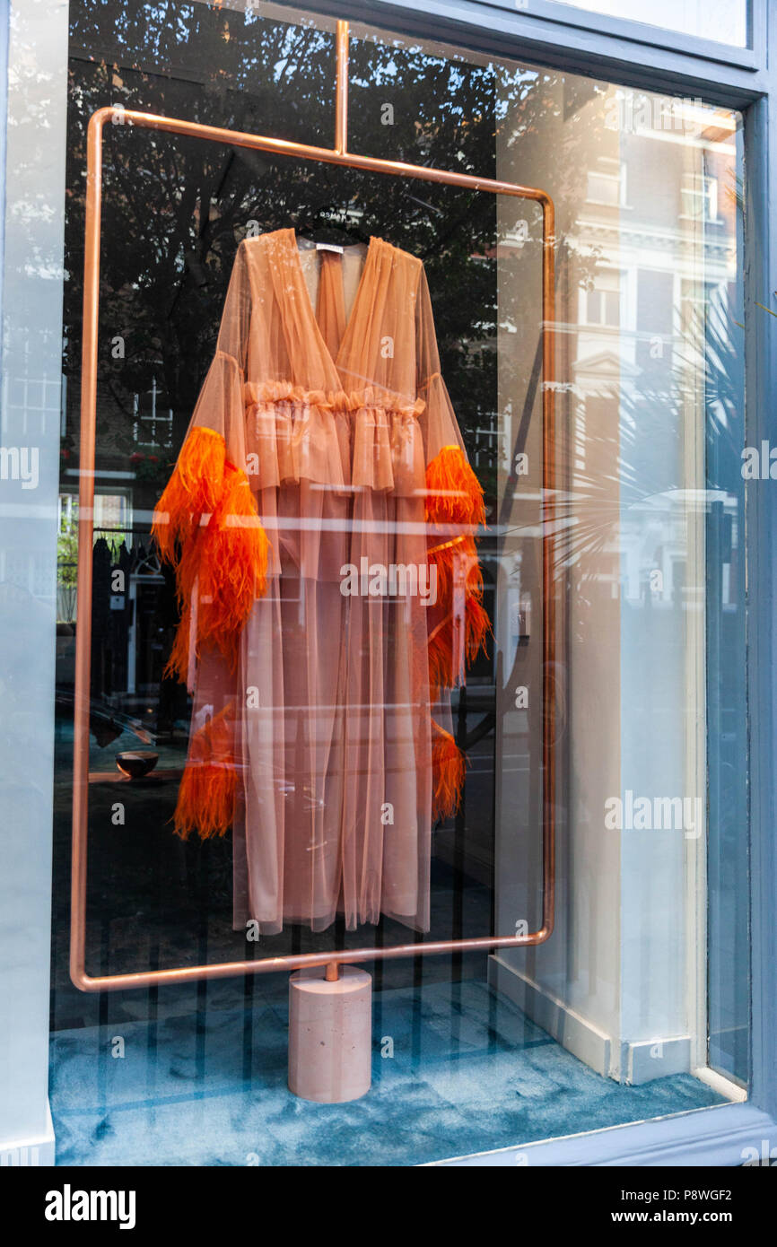 Exotic dress hanged inside a shop window, London, England, UK Stock ...