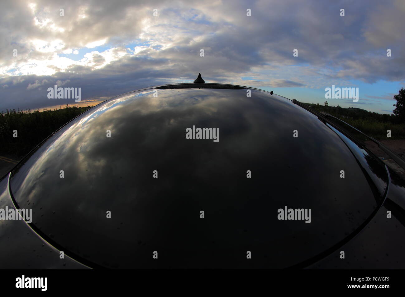 Cloud reflections on the rear window of a car Stock Photo - Alamy