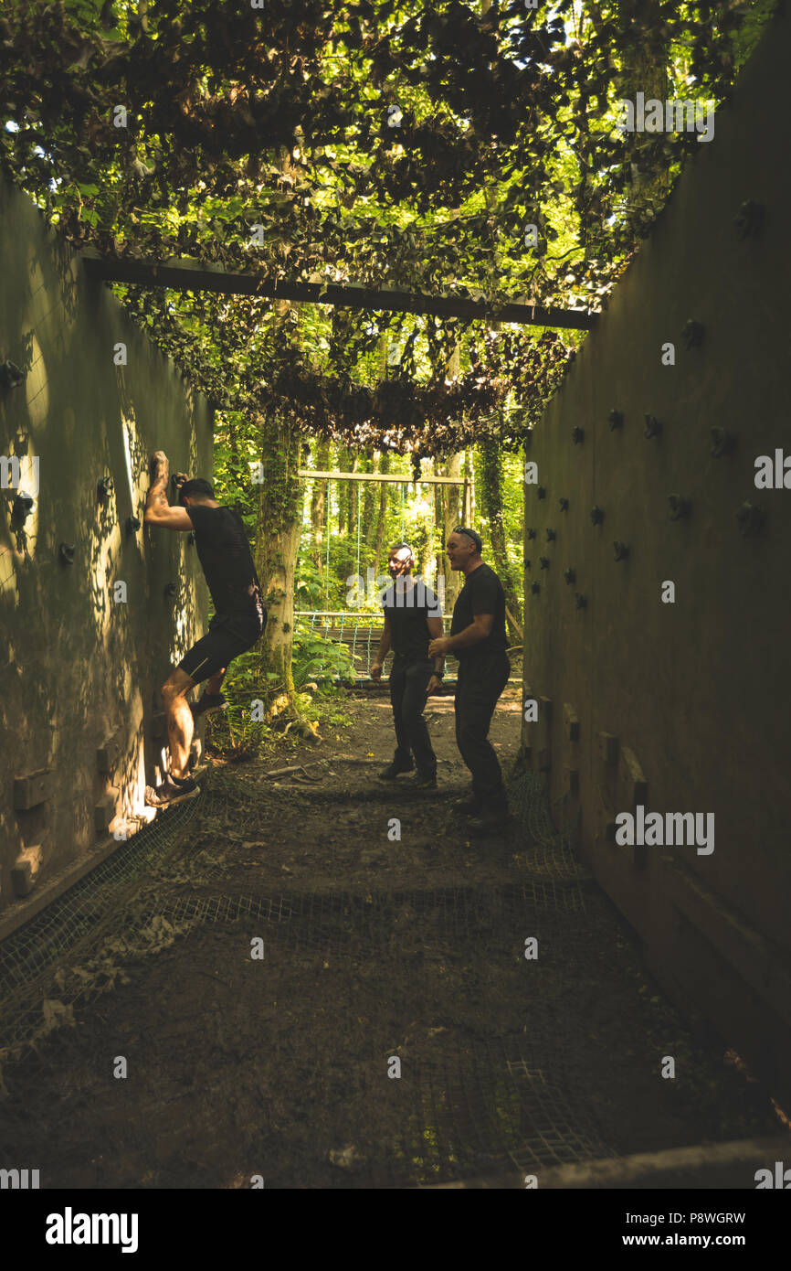 Fit man training over obstacle course Stock Photo - Alamy