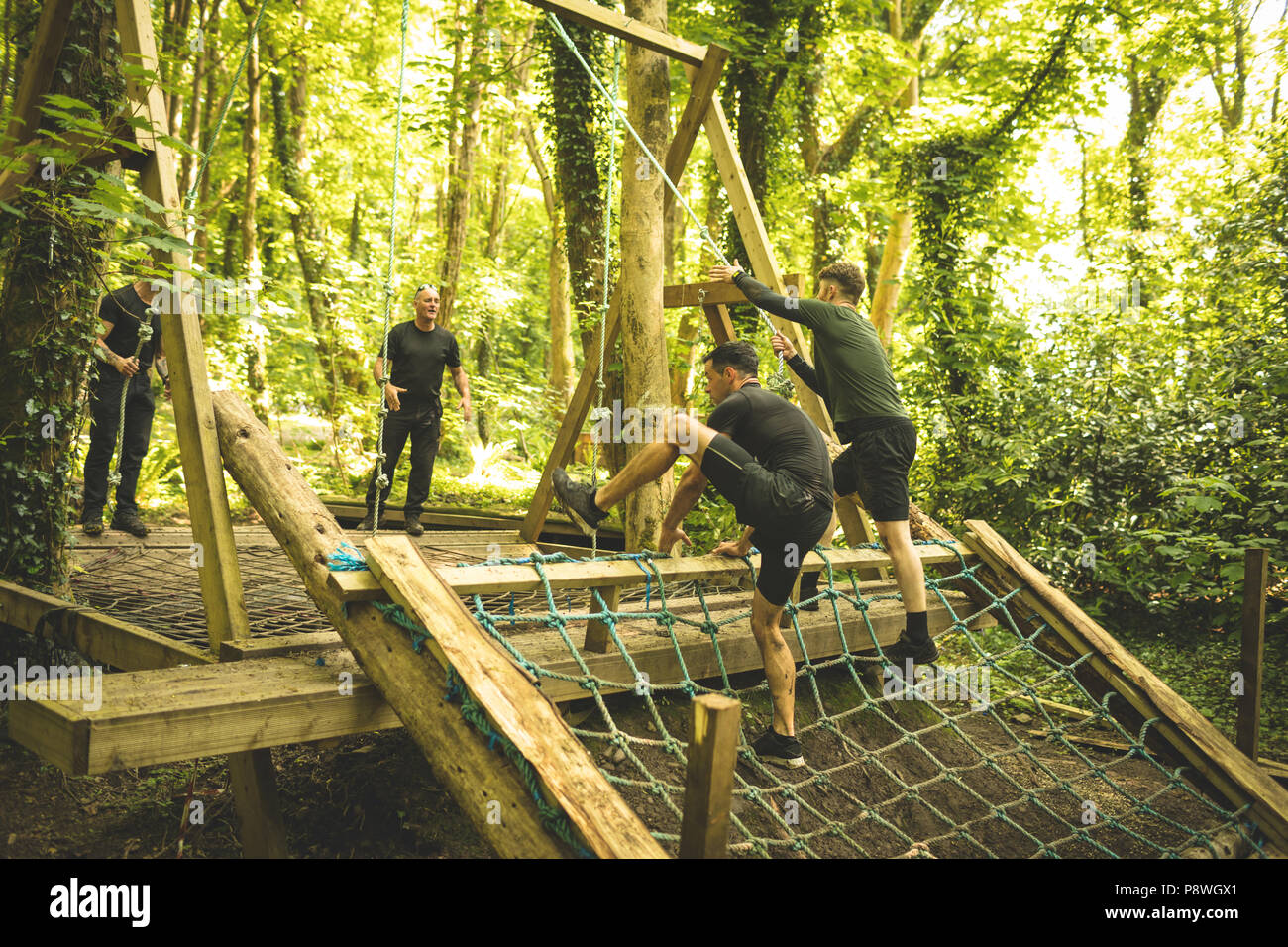 Fit mens training over obstacle course Stock Photo - Alamy