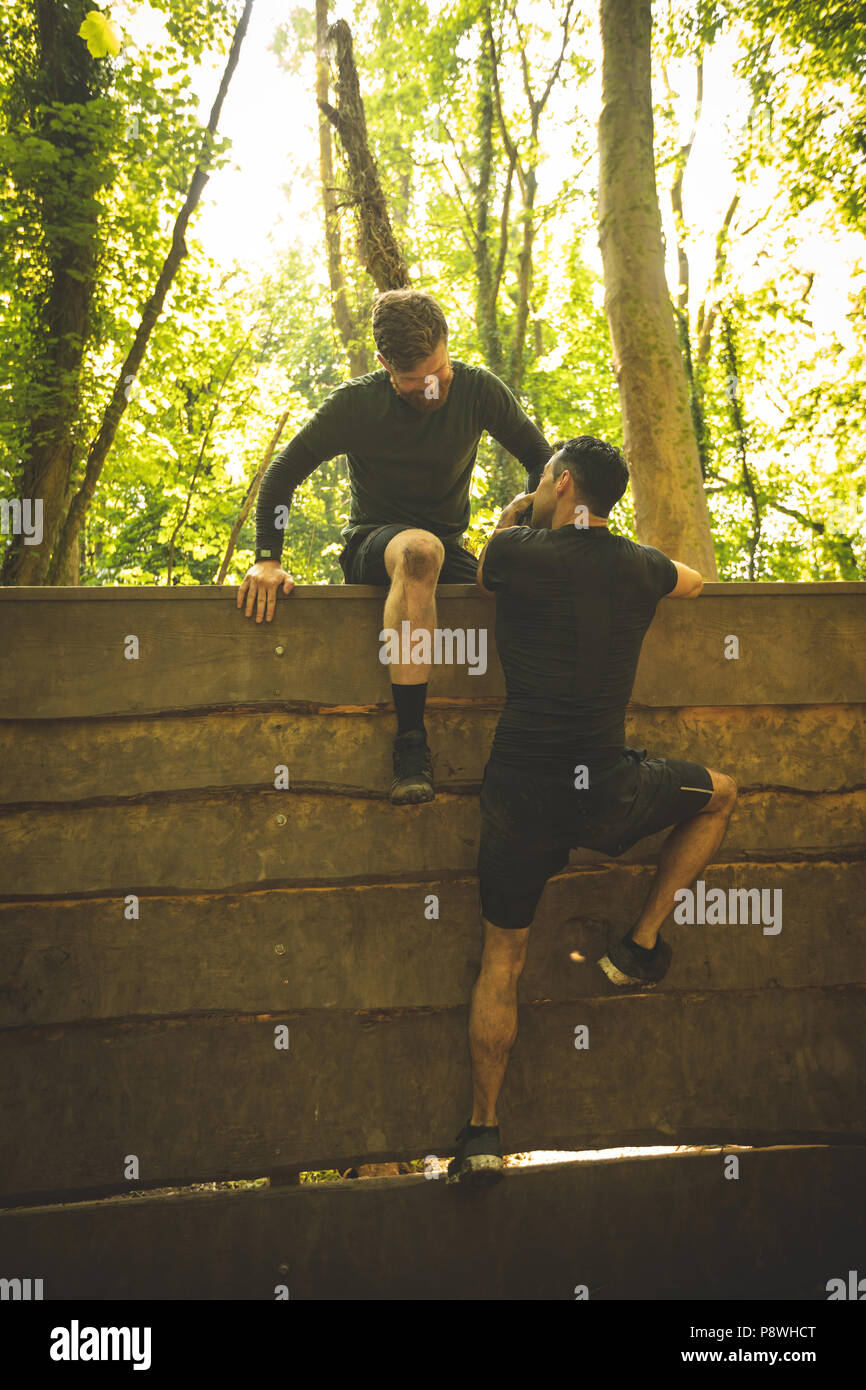 Fit mens training over obstacle course Stock Photo - Alamy