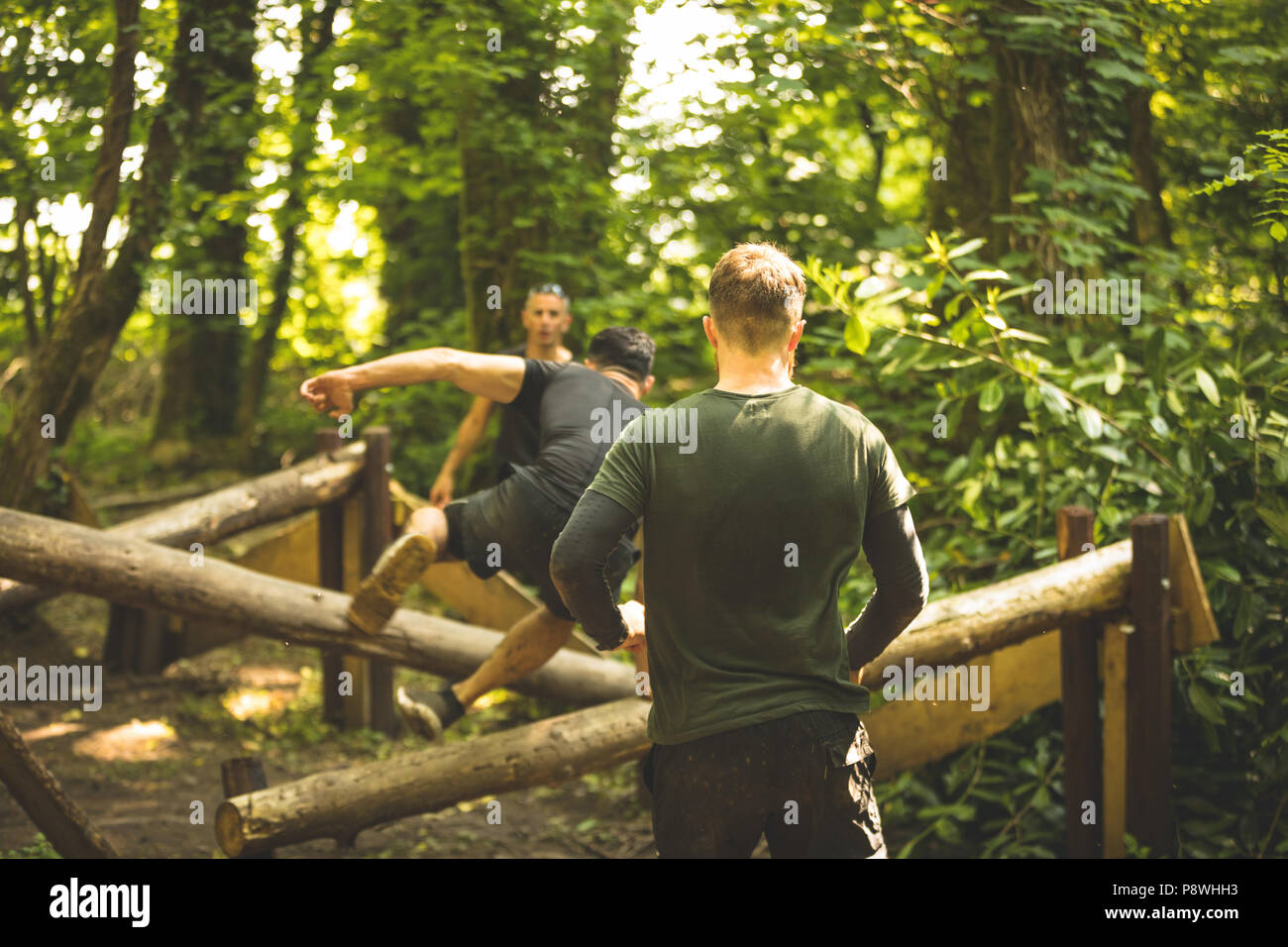 Fit mens training over obstacle course Stock Photo - Alamy
