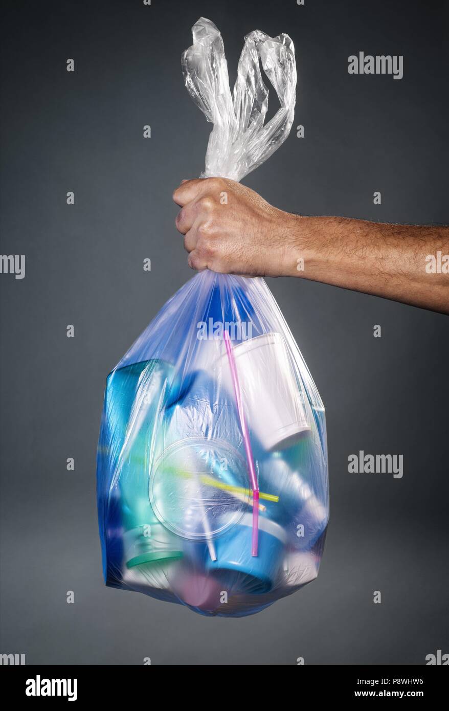Hand holding a bag of plastic waste | usage worldwide Stock Photo - Alamy