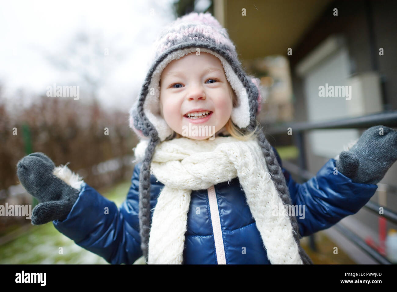 Adorable little girl wearing winter hat making funny faces on beautiful ...