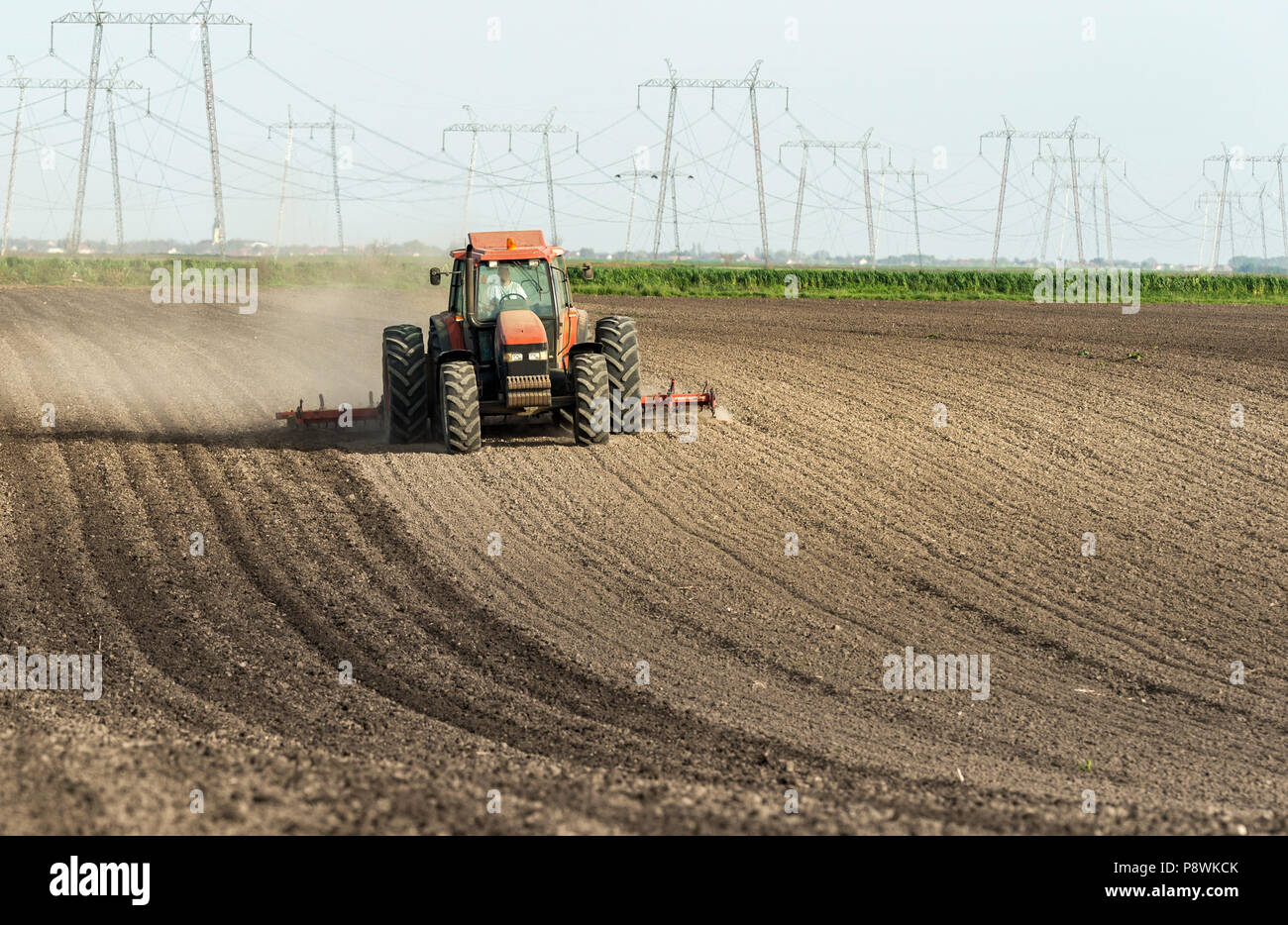 Tractor preparing land for sowing Stock Photo - Alamy