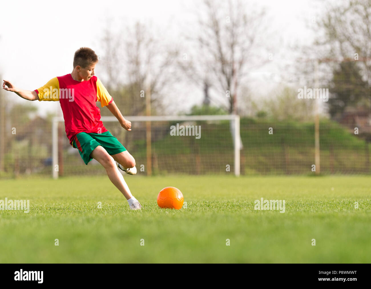 Boy boys kicking a ball hi-res stock photography and images - Alamy