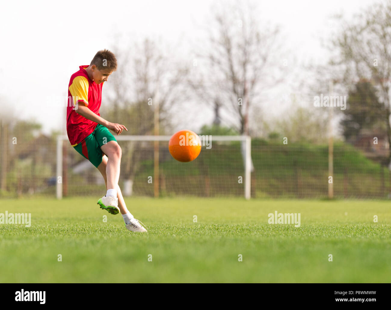 Boy boys kicking a ball hi-res stock photography and images - Alamy