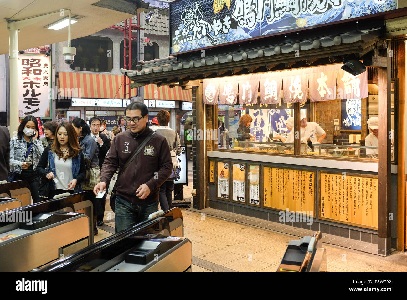 Commuters at Juso Station on Hankyu Railways Kobe line. This is one of ...