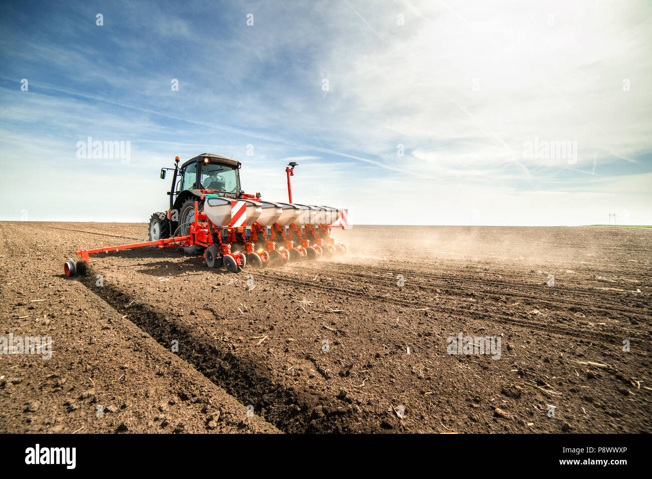 Farmer seeding crops at field Stock Photo - Alamy